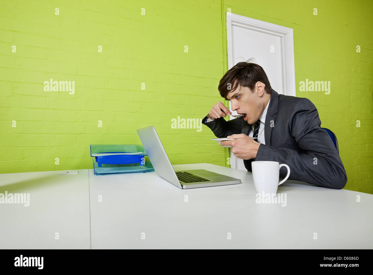 Man eating and working with laptop hi-res stock photography and images ...