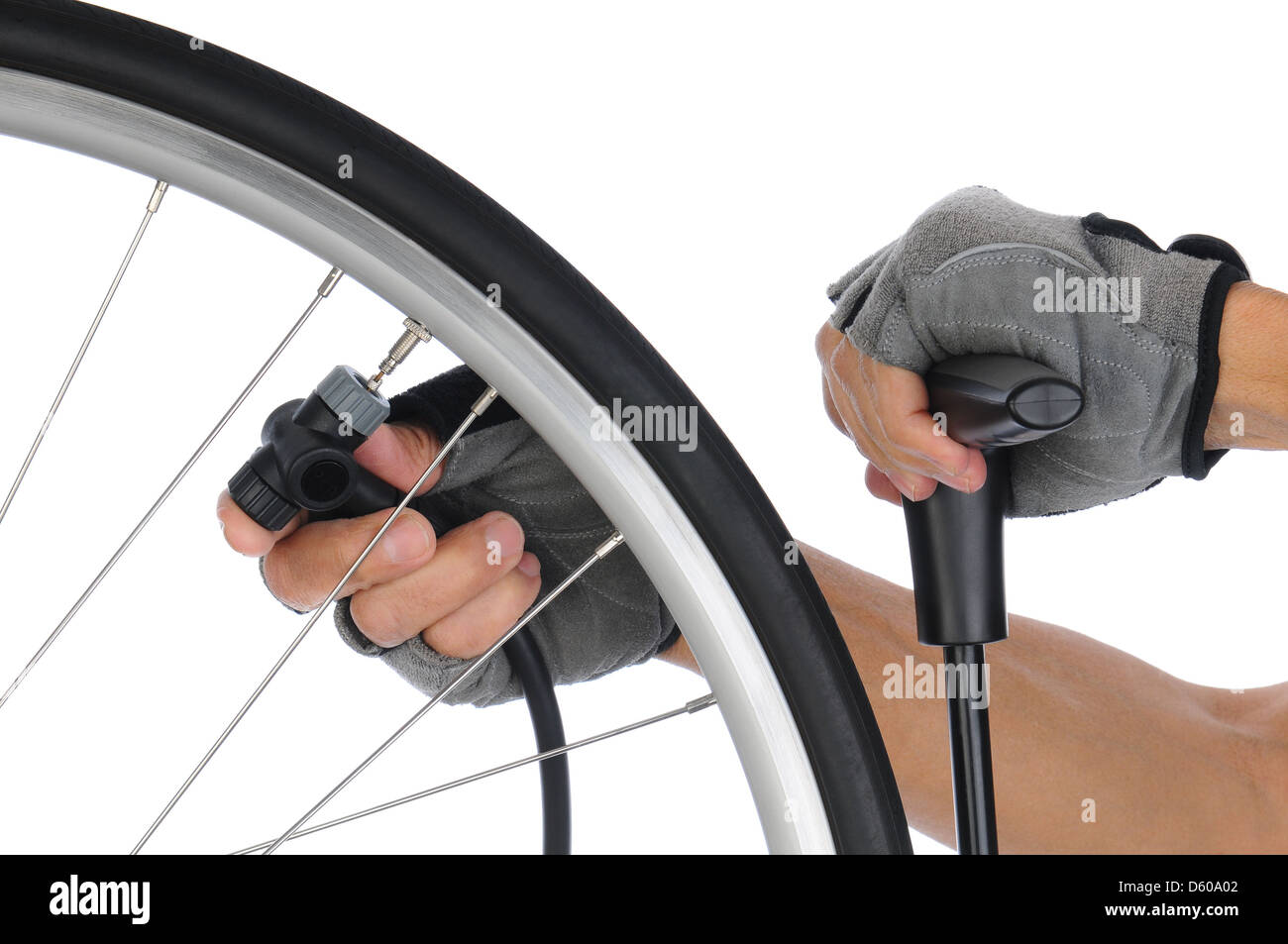 Closeup of a cyclists hands attaching an air pump to the stem of his ...