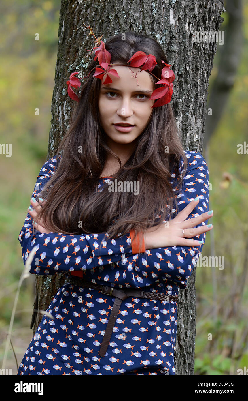 The beautiful girl stands a tree Stock Photo - Alamy