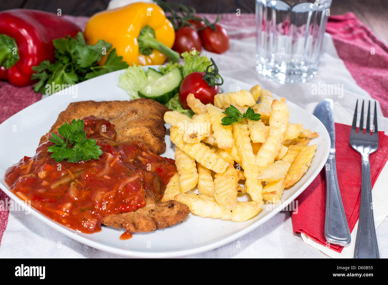 Fresh made Schnitzel with Sauce and Chips Stock Photo - Alamy