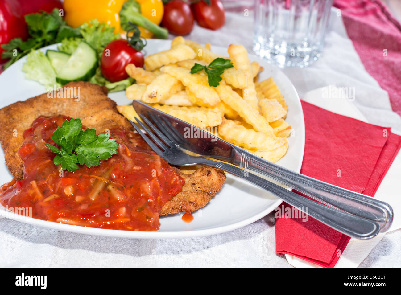 Fresh made Schnitzel with Sauce and Chips Stock Photo - Alamy