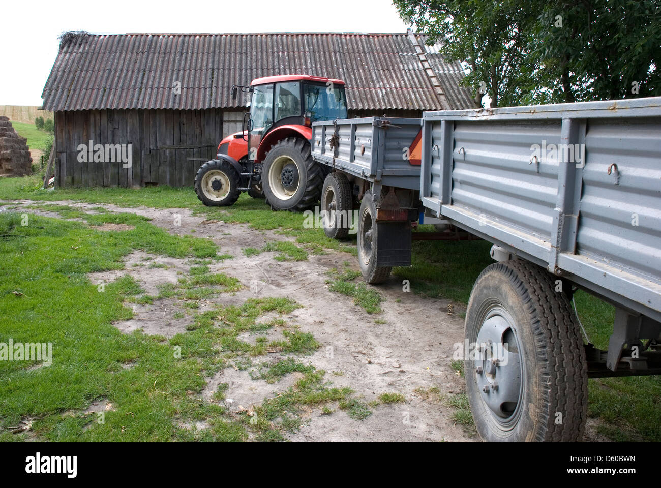 Tractor and trailer on a farm in Poland Stock Photo - Alamy