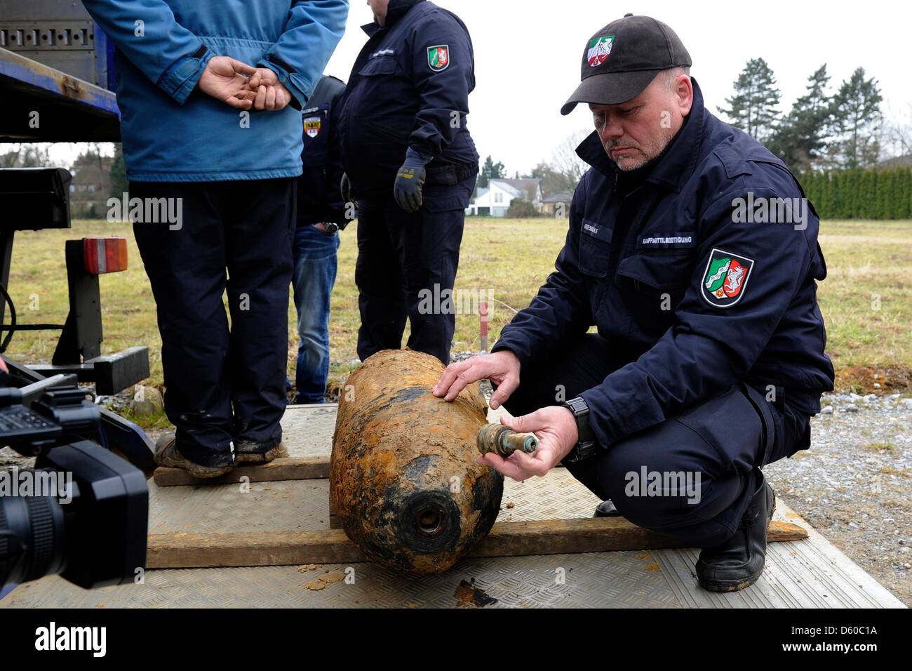 Peter Giesecke of the explosive ordnance disposal kneels next to a ...