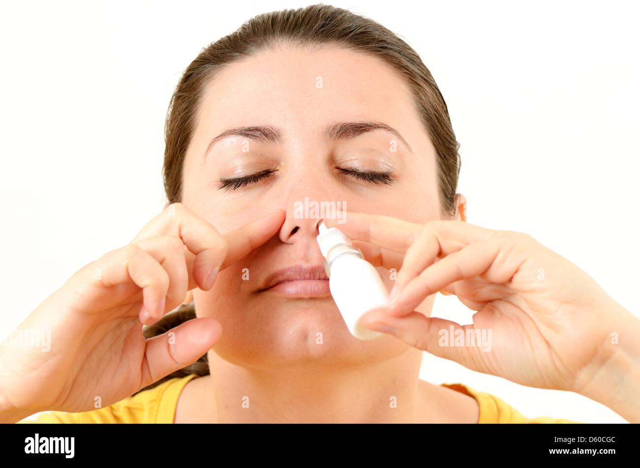Woman using nasal spray Stock Photo - Alamy