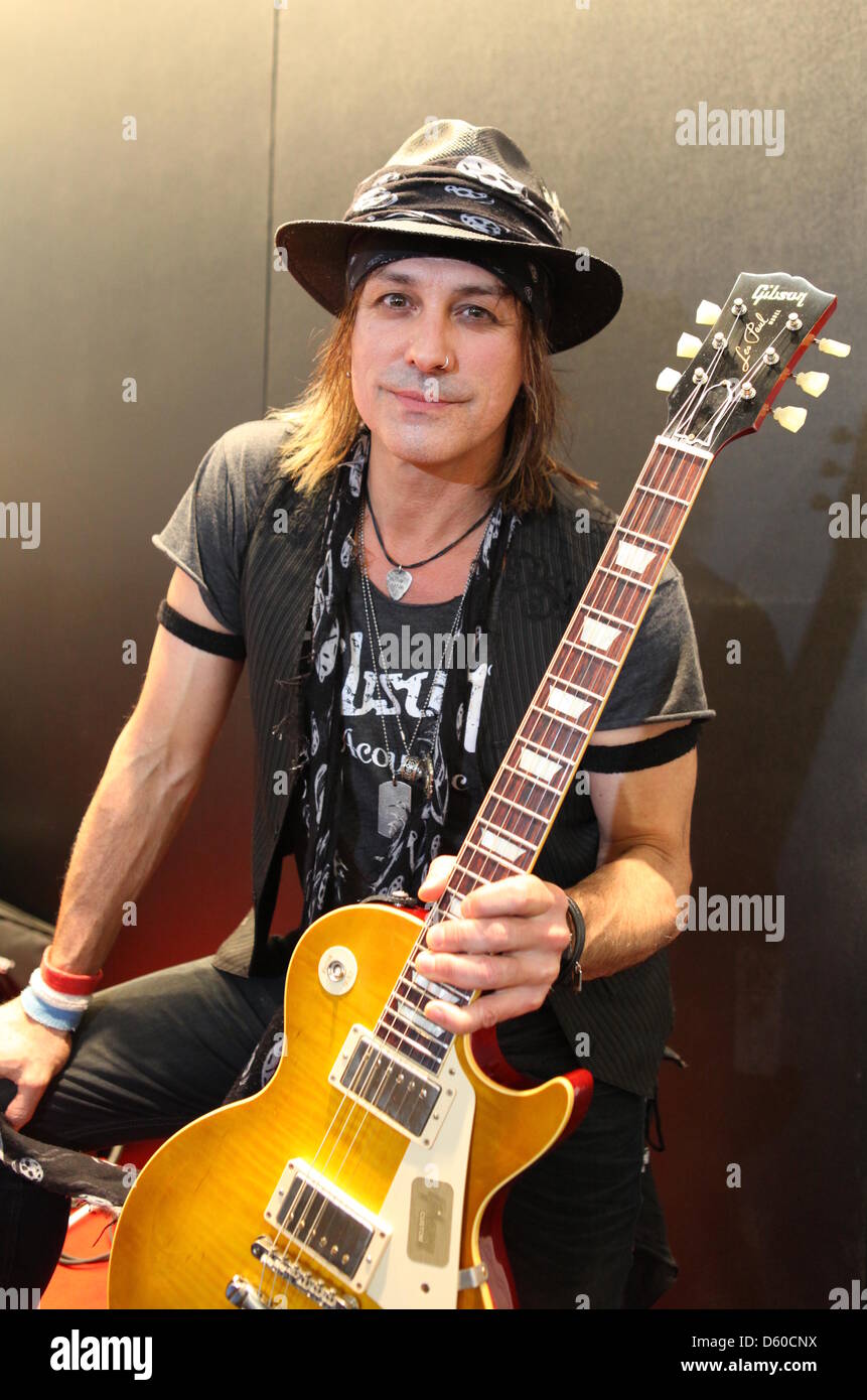 Guitarist Ryan Roxy (Alice Cooper) poses at the exhibition booth of ...