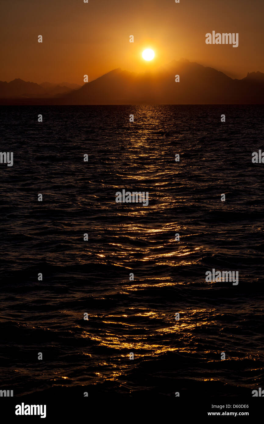 Sunset over a Mountains Stock Photo - Alamy