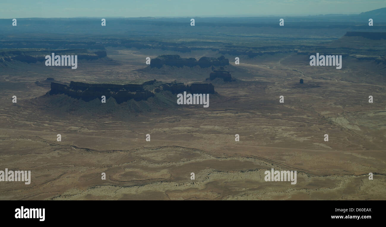 Aerial view, west to Piute Mesa, mesas buttes rising dry stream ...