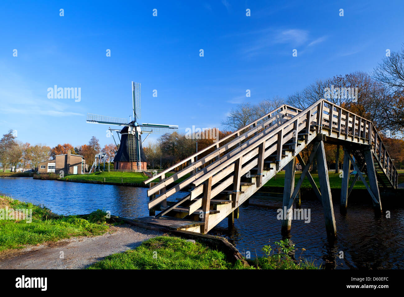 Dutch windmill and bridge Stock Photo - Alamy