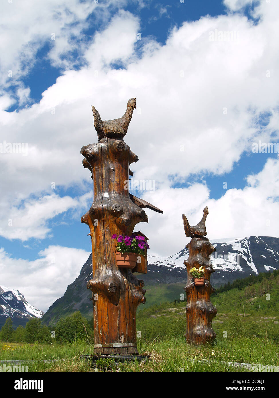 Two tree posts carved with a pheasant, Geiranger,Norway Stock Photo - Alamy