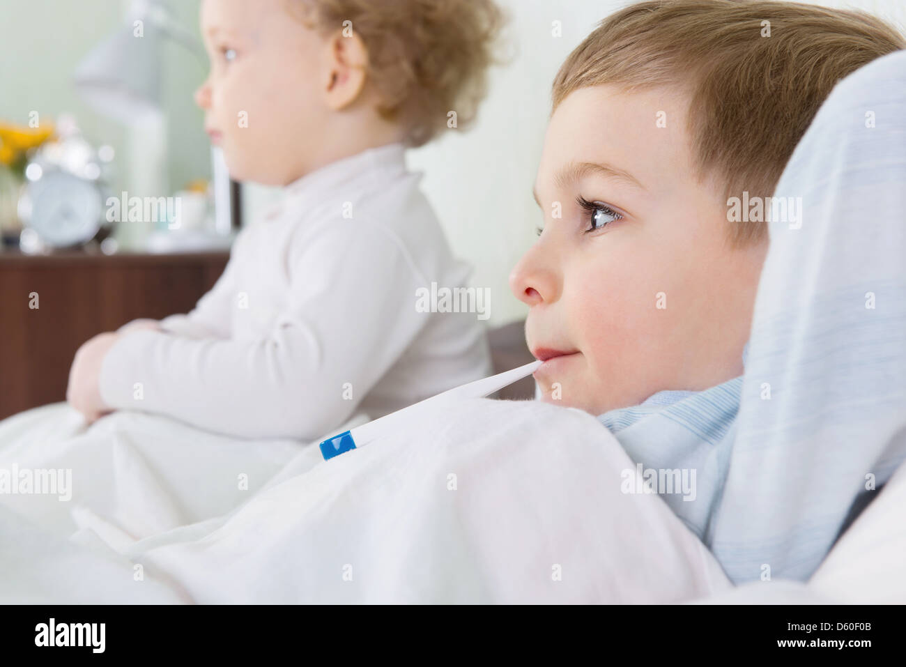 Little girl and her sick brother lying in bed at home Stock Photo - Alamy