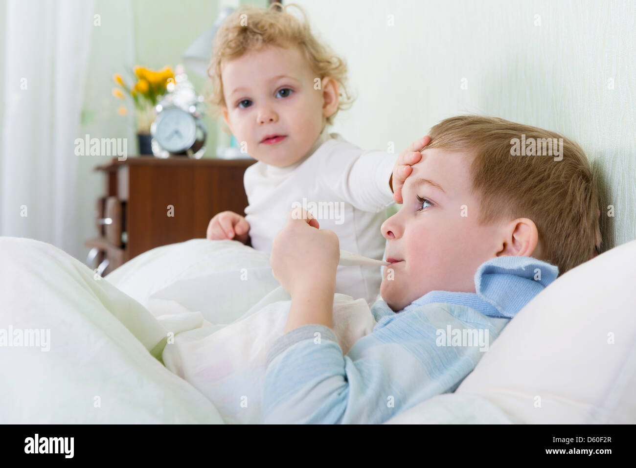 Little girl and her sick brother lying in bed at home Stock Photo - Alamy