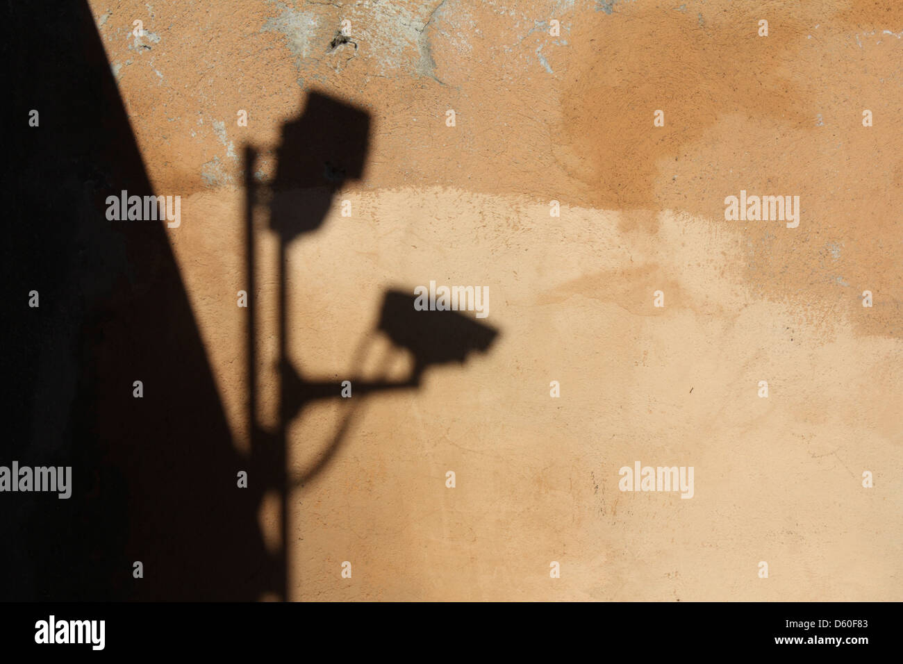 one cctv camera on high pole outdoors shadow on wall Stock Photo - Alamy
