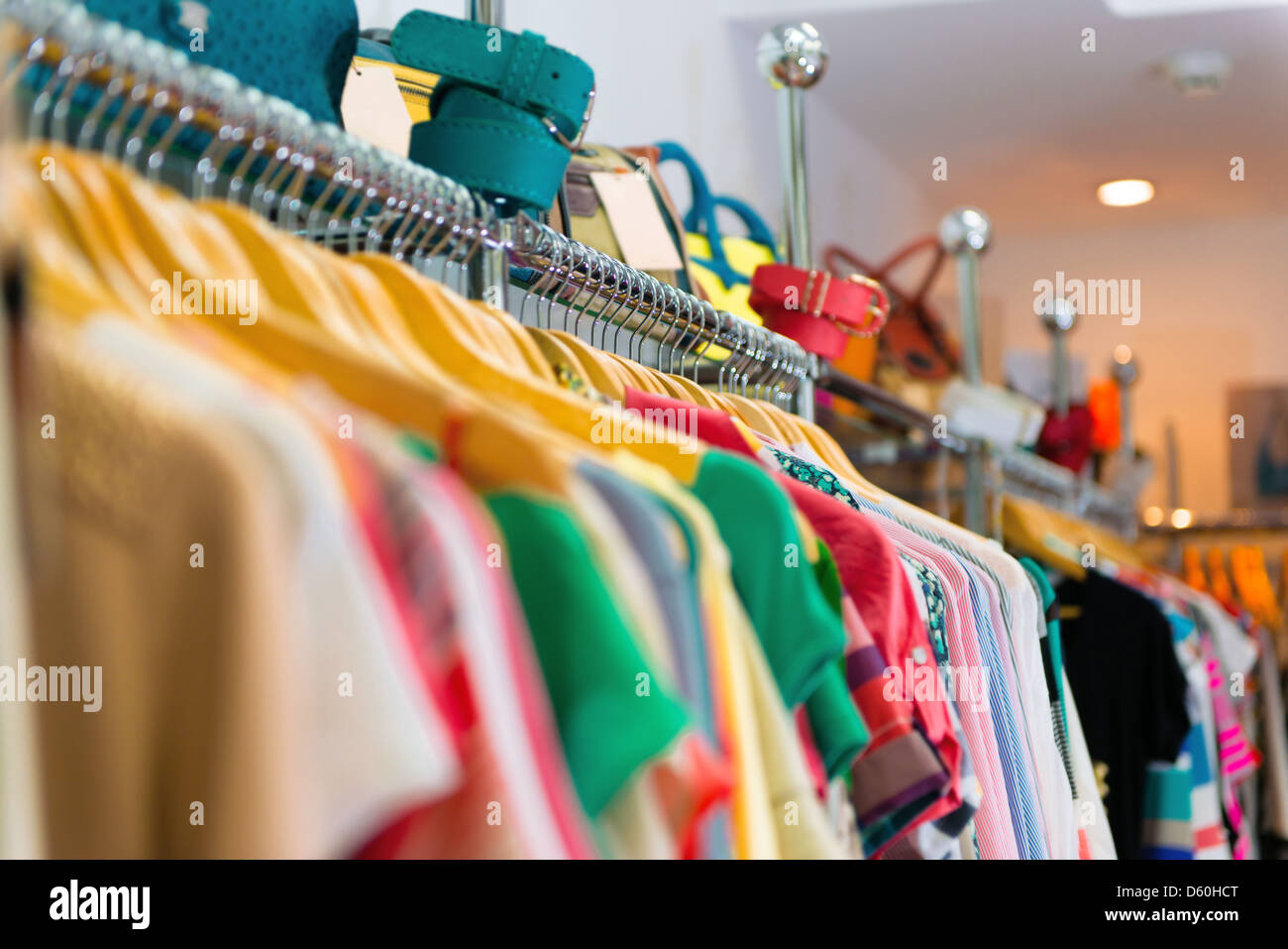 Variety of clothes hanging on rack in boutique Stock Photo - Alamy