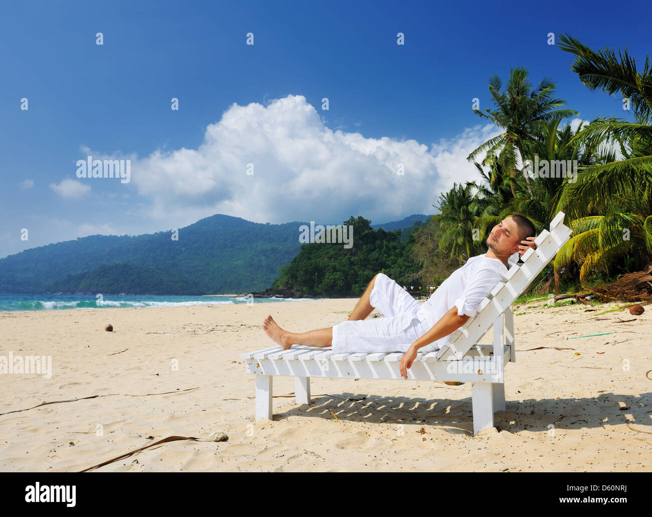 Man relaxing on a beach Stock Photo - Alamy