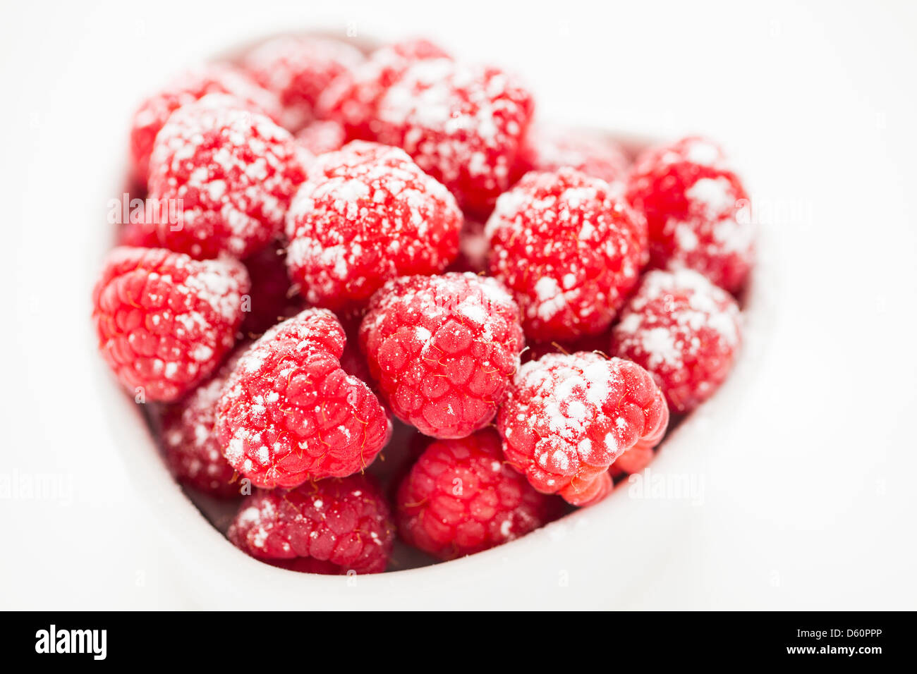 Raspberries in heart shaped ramekin Stock Photo - Alamy