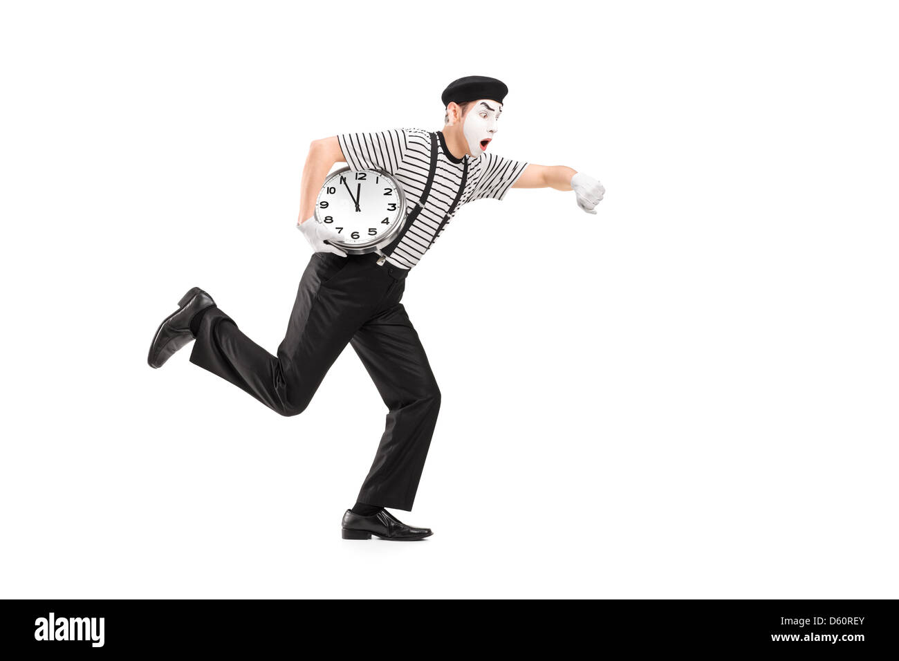 Full length portrait of a mime artist holding a clock and running late ...