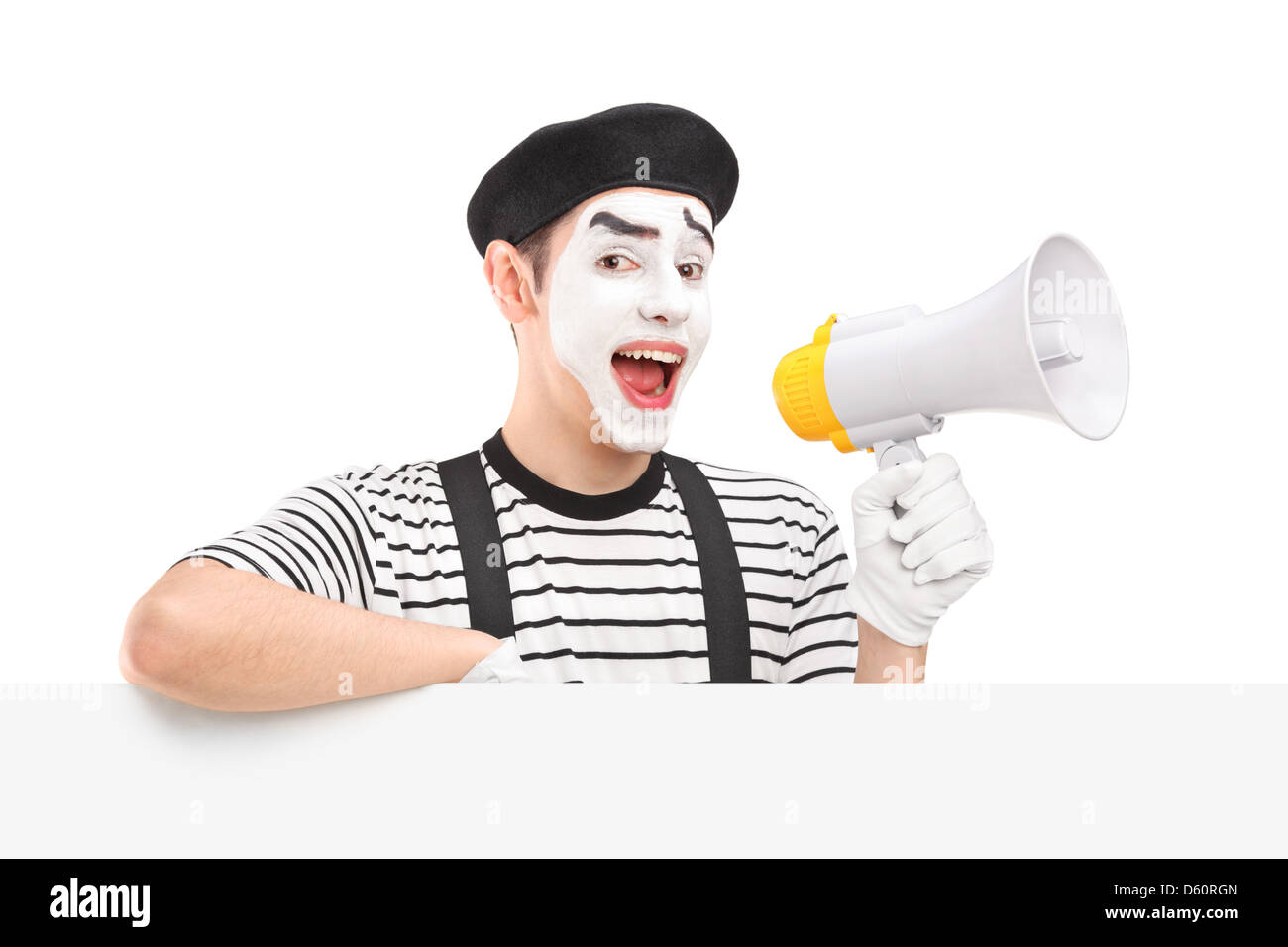 Male mime artist holding a loudspeaker and posing on a blank panel ...