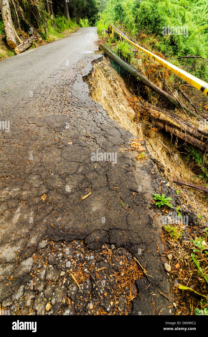 A dangerous damaged road that has fallen down the hillside Stock Photo ...