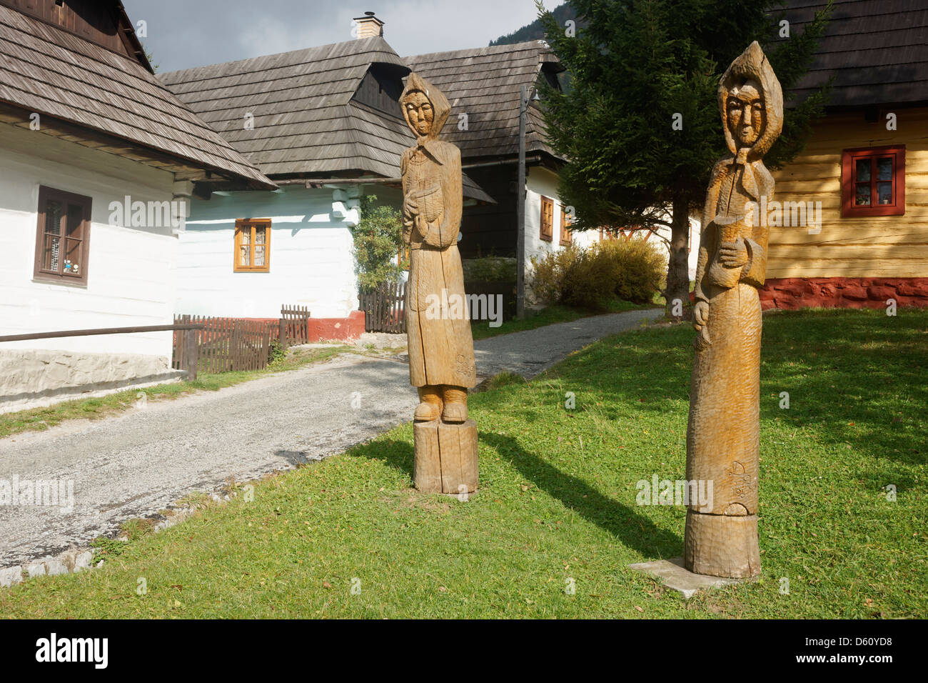 Traditional houses and wooden statues in Vlkolinec, Slovakia. UNESCO ...