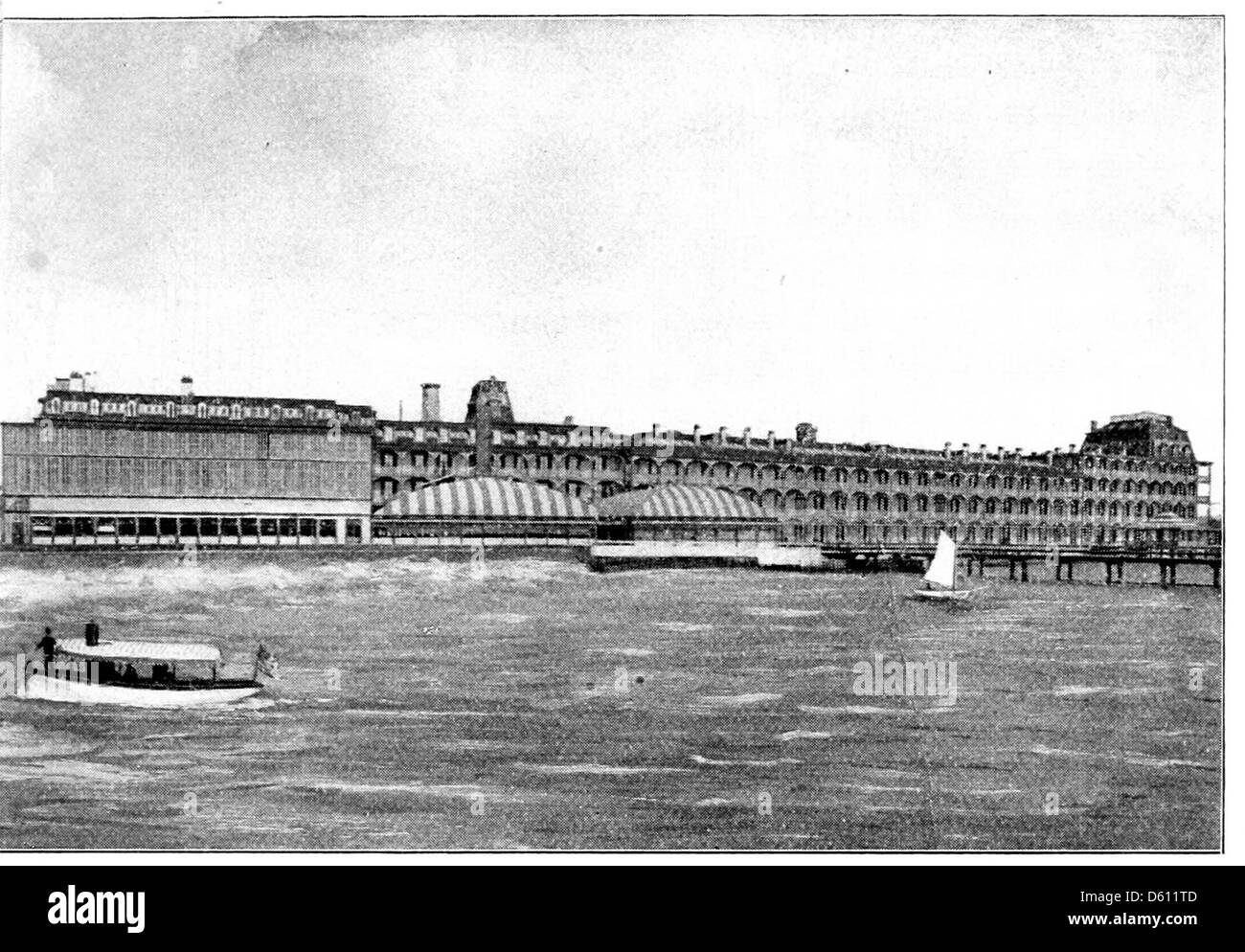 A hotel porter stands at the entrance of a historic hotel, exemplifying ...