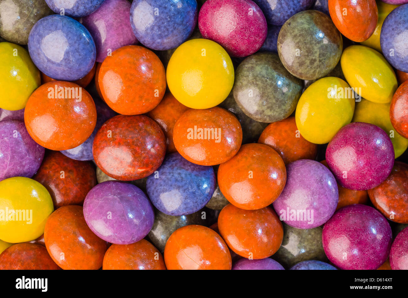 Group of colorful chocolate candies on a table Stock Photo - Alamy