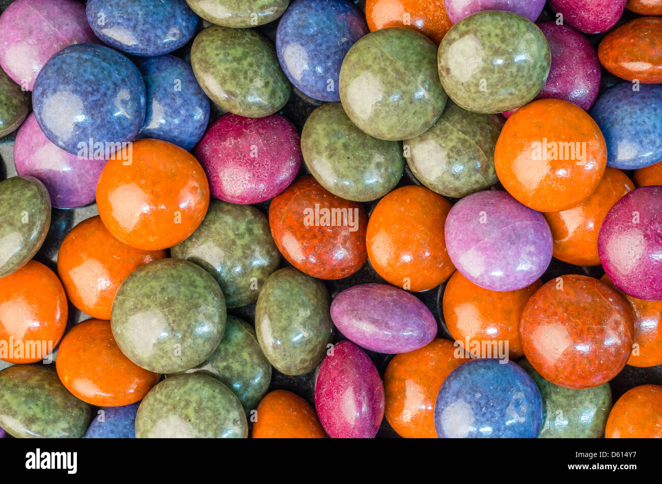 Group of colorful chocolate candies on a table Stock Photo - Alamy