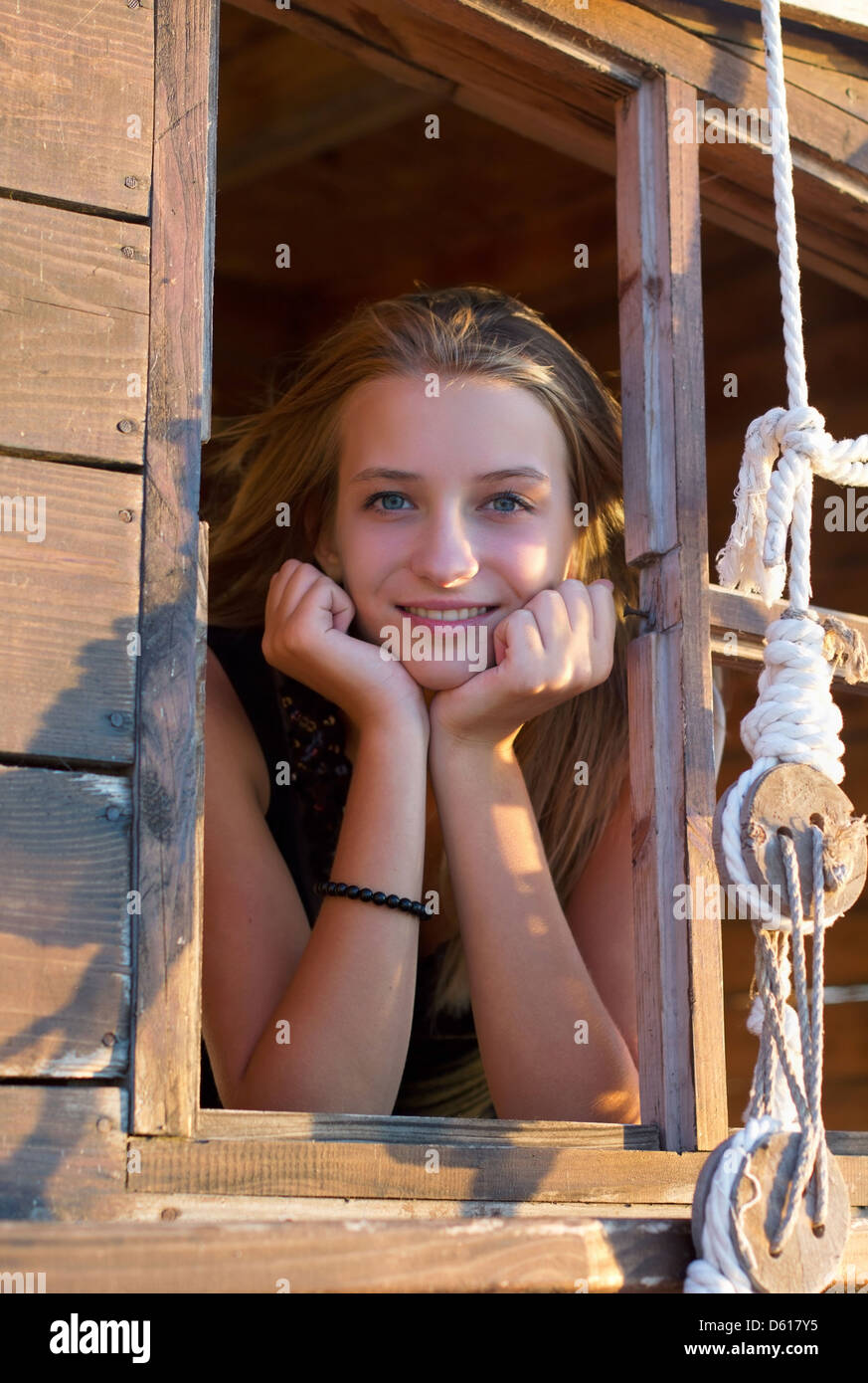 Girl in the window Stock Photo - Alamy