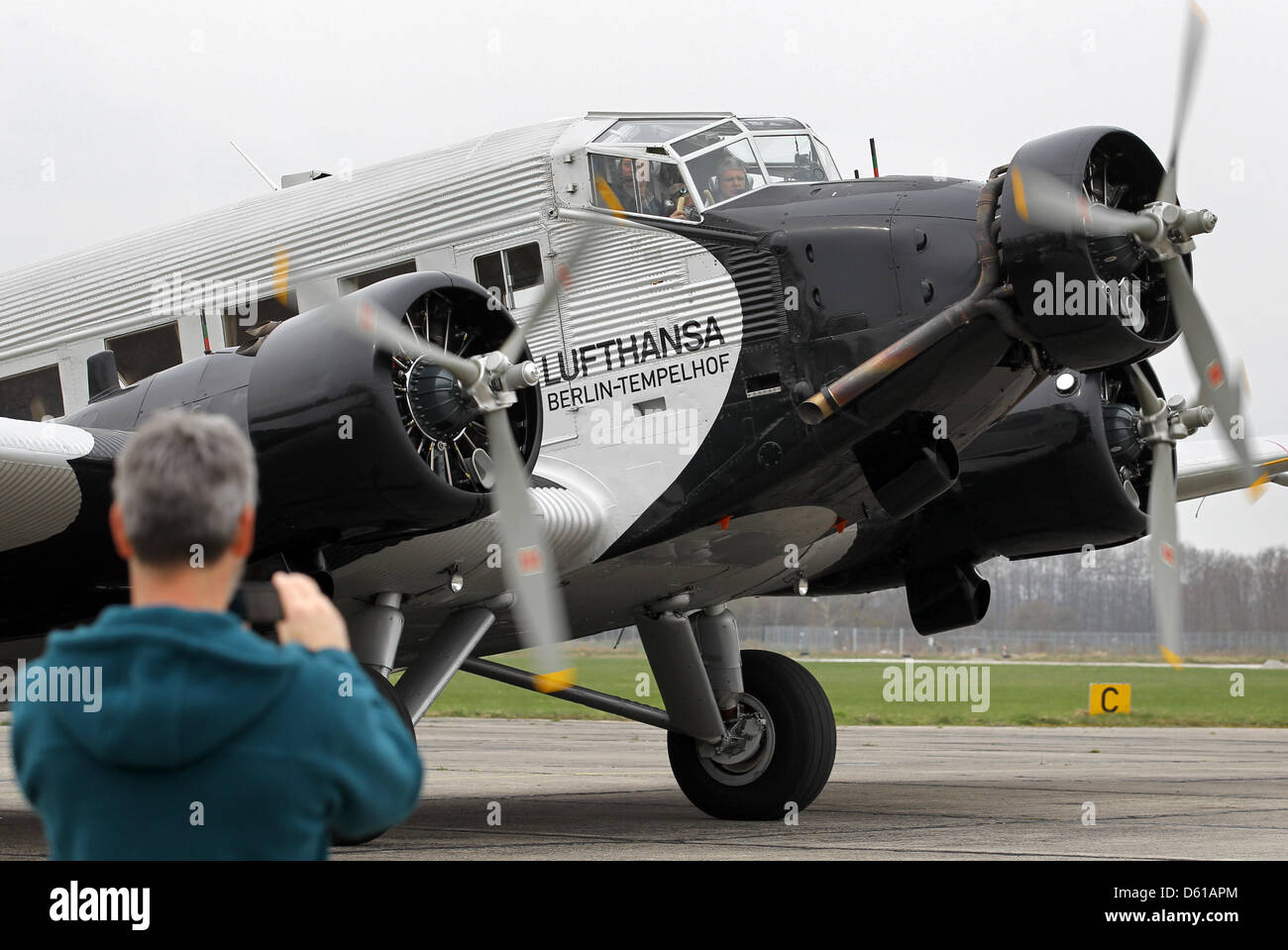 Curious onlookers follow the start of a 76 year old Junkers Ju 52 of ...