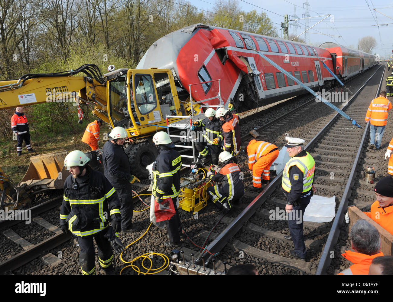 A firefighters and rescue teams stand at the site of a train accident ...