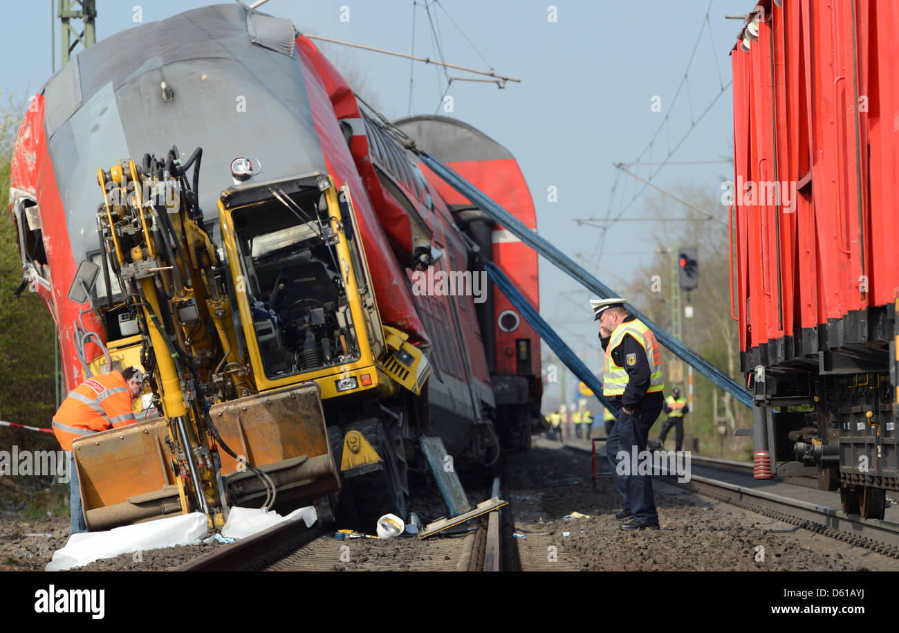 A firefighters and rescue teams stand at the site of a train accident ...