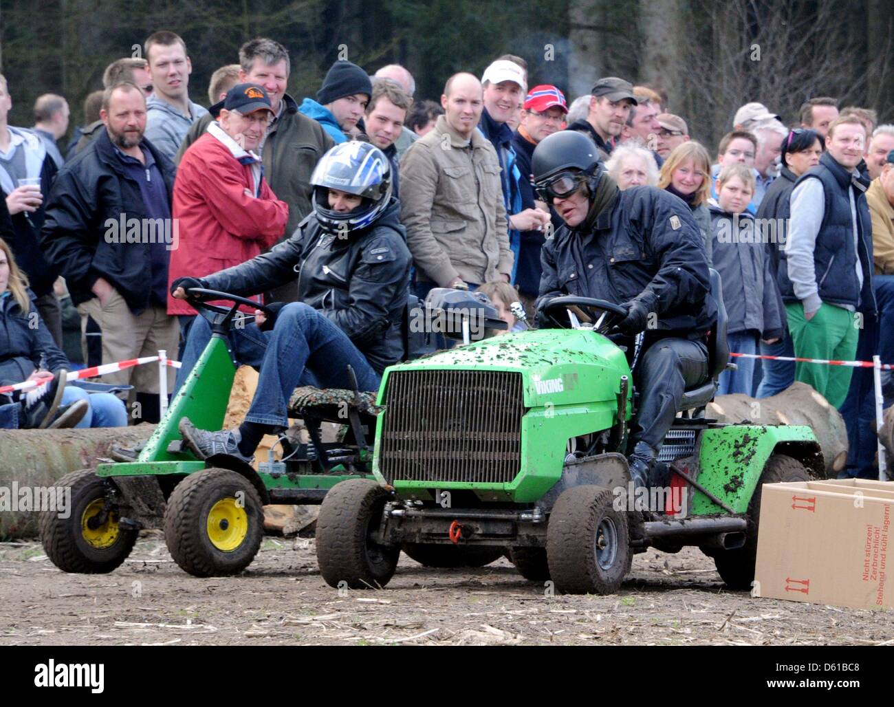 Two participants compete in a ride-on mower race in Aukrug-Homfeld ...