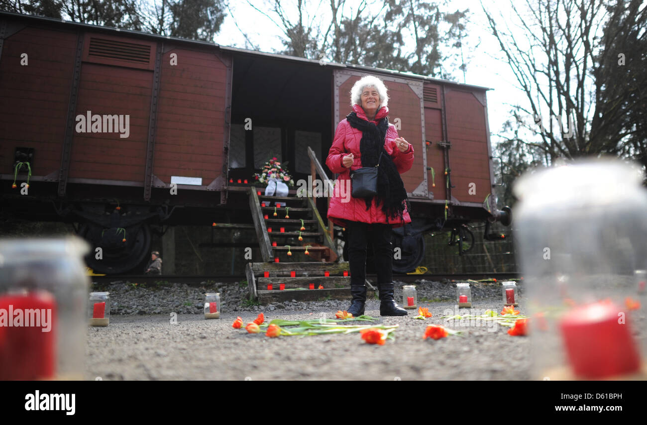 Witness Fanny Heymann poses in front of a railway wagon at the memorial ...