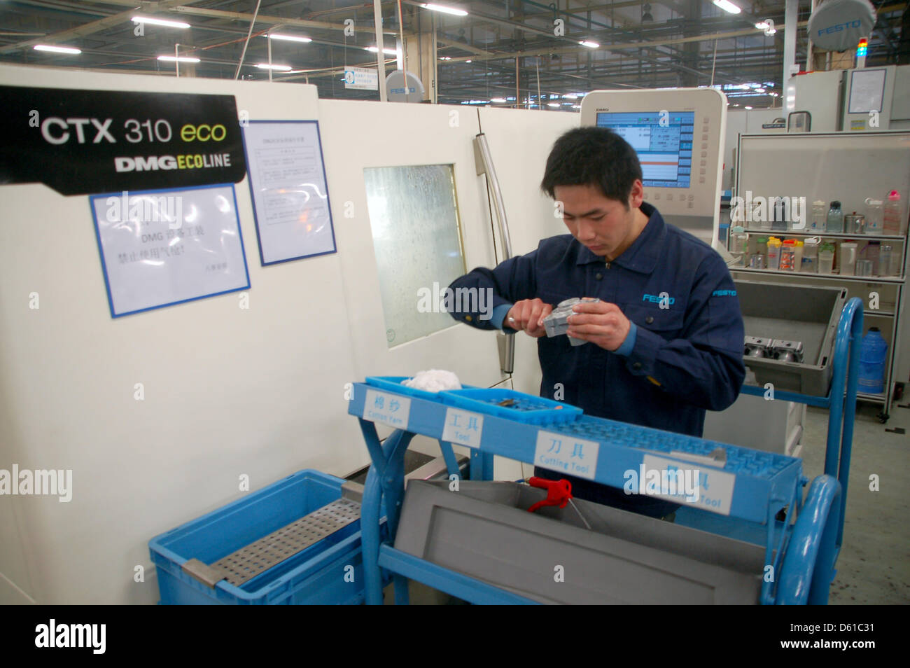 An employee of the industrial control and automation company Festo ...