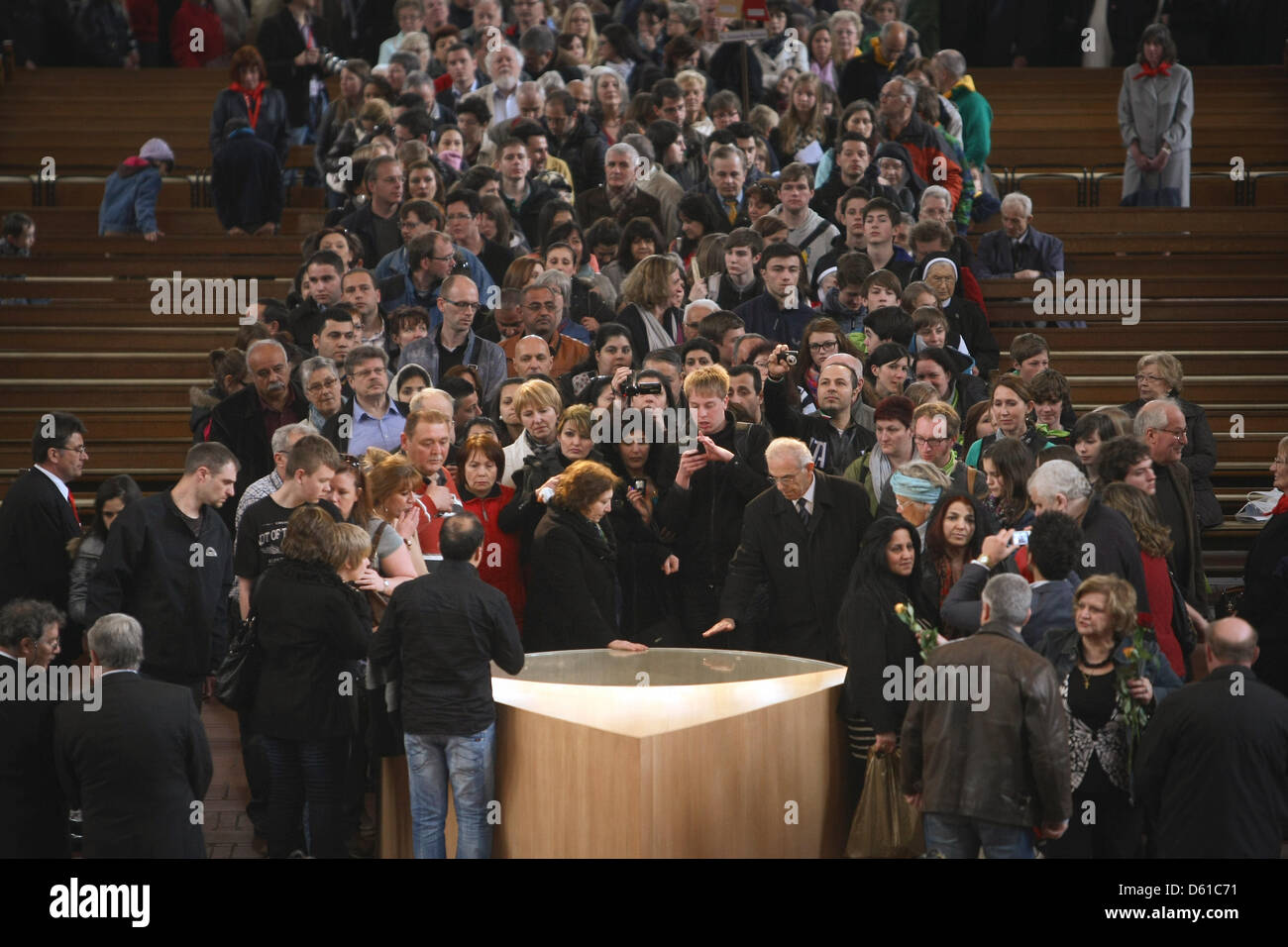 Visitors take a close look at the relic of the 'Holy Robe of Treves' at ...