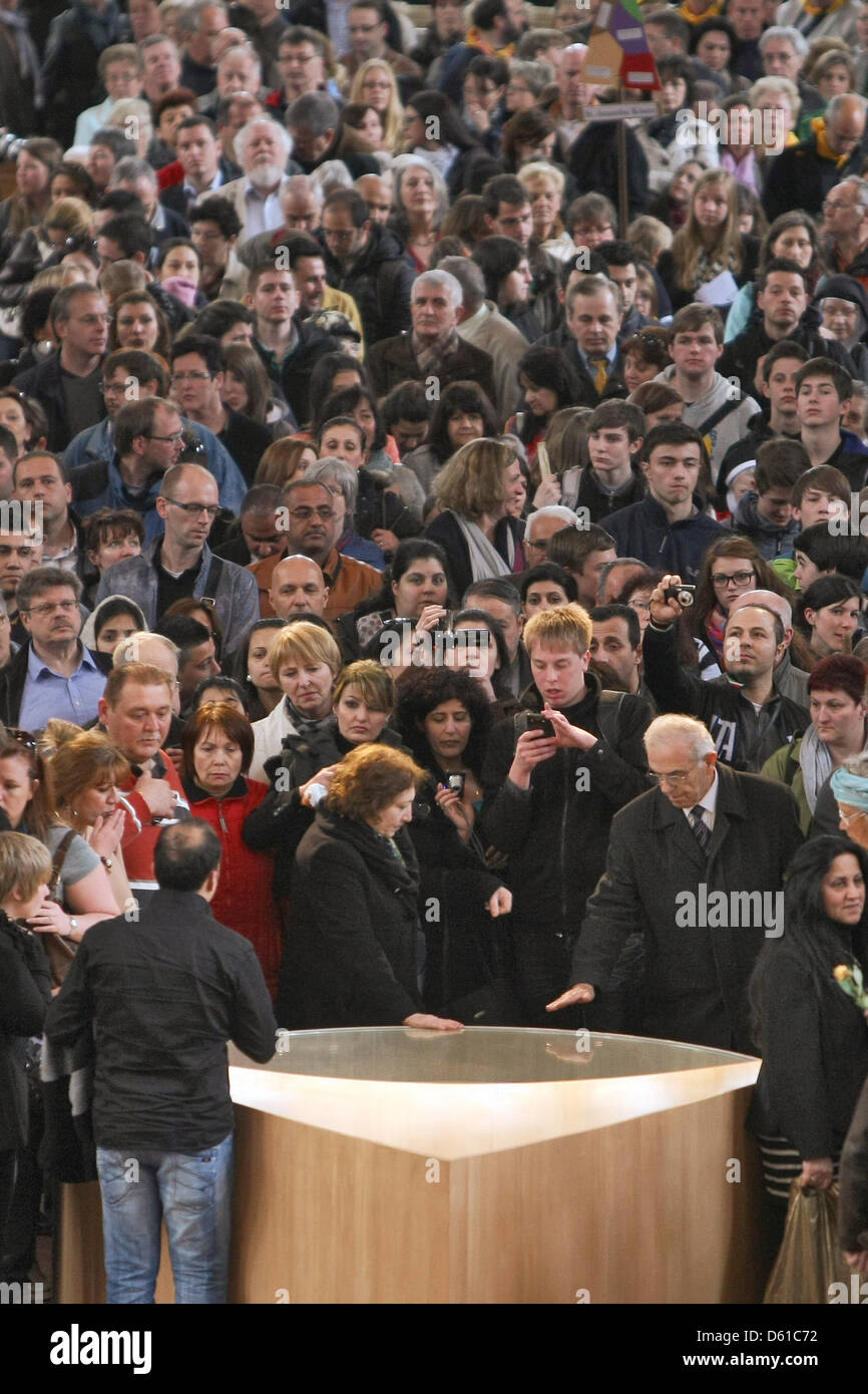 Visitors take a close look at the relic of the 'Holy Robe of Treves' at ...