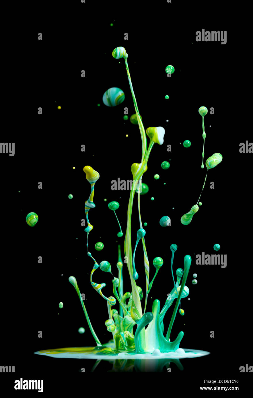 colorful paint jumping and dancing against black background Stock Photo ...