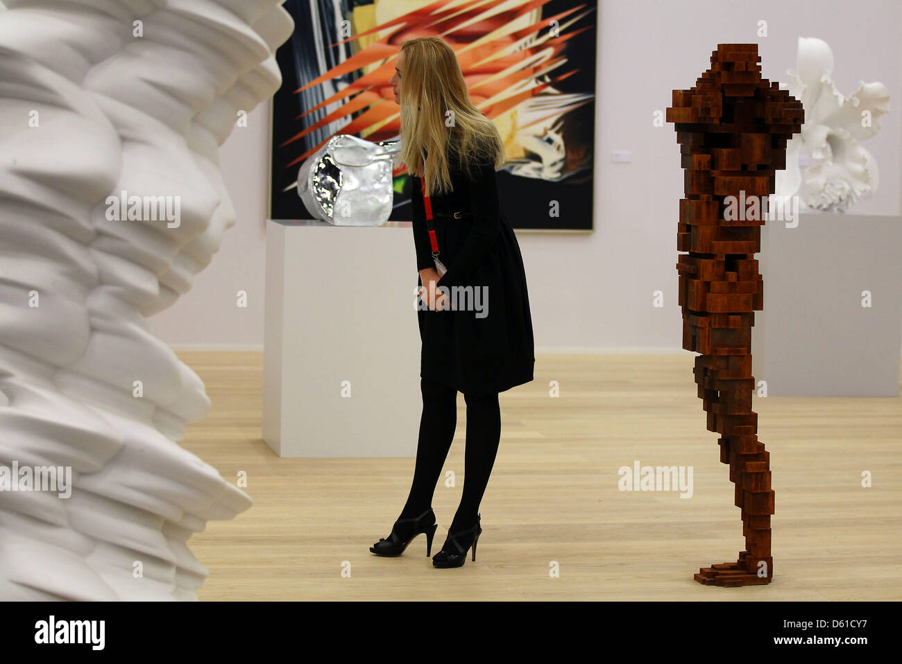 A woman stands next to the work 'Shrive X' by Antony Gormley (R) at the ...
