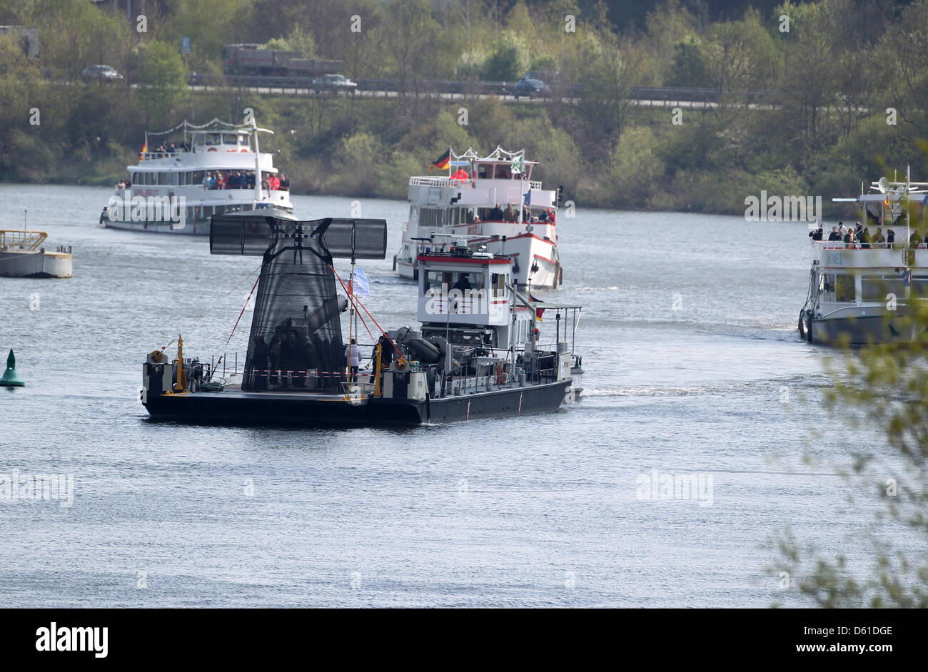 A boat carries an oversized replica of the Holy Robe during the Holy ...