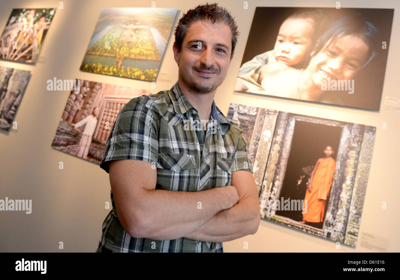 Photographer Martin Engelmann poses in front of his works in an office ...