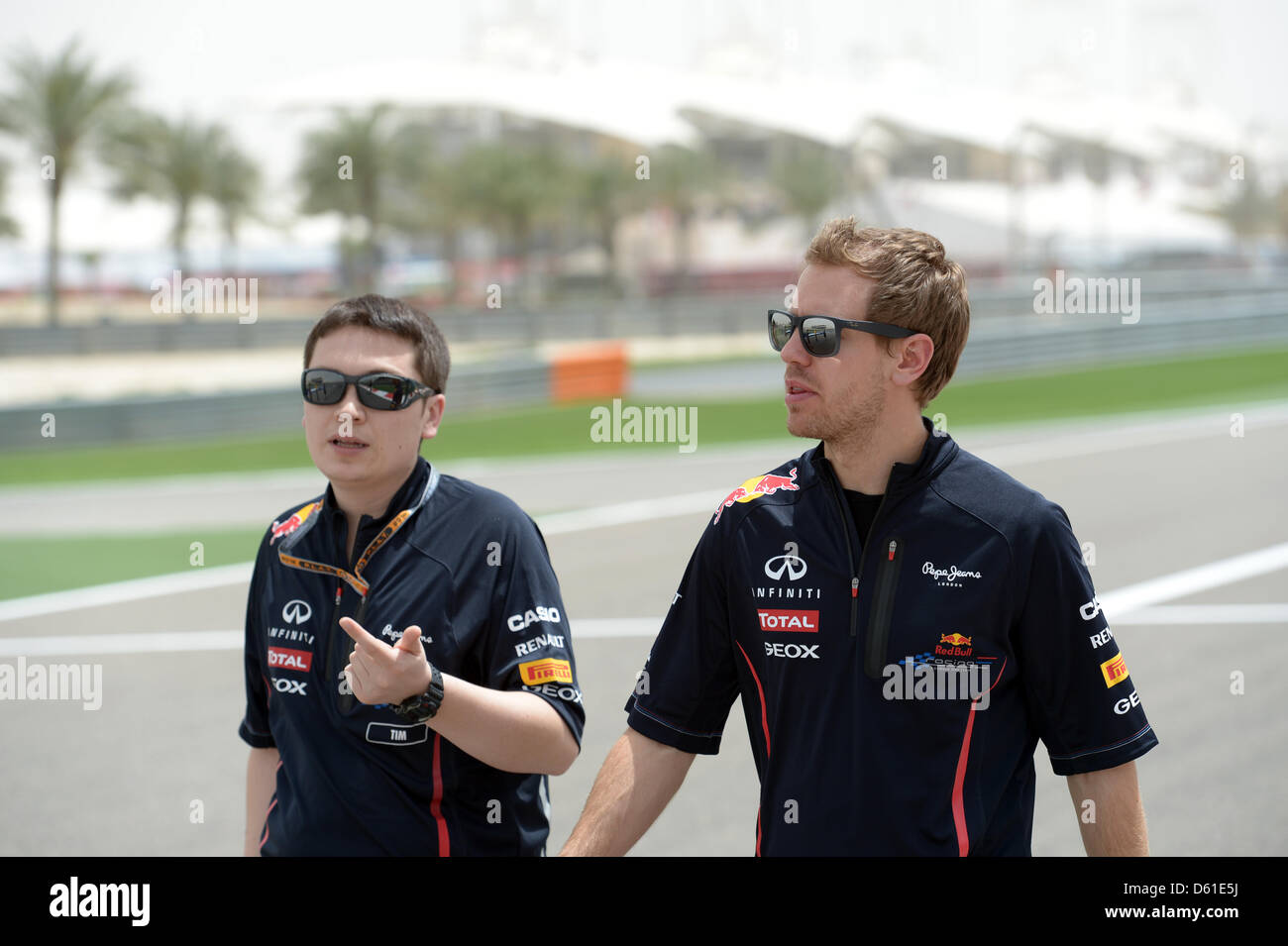 German Formula One driver Sebastian Vettel (R) of Red Bull walks with ...