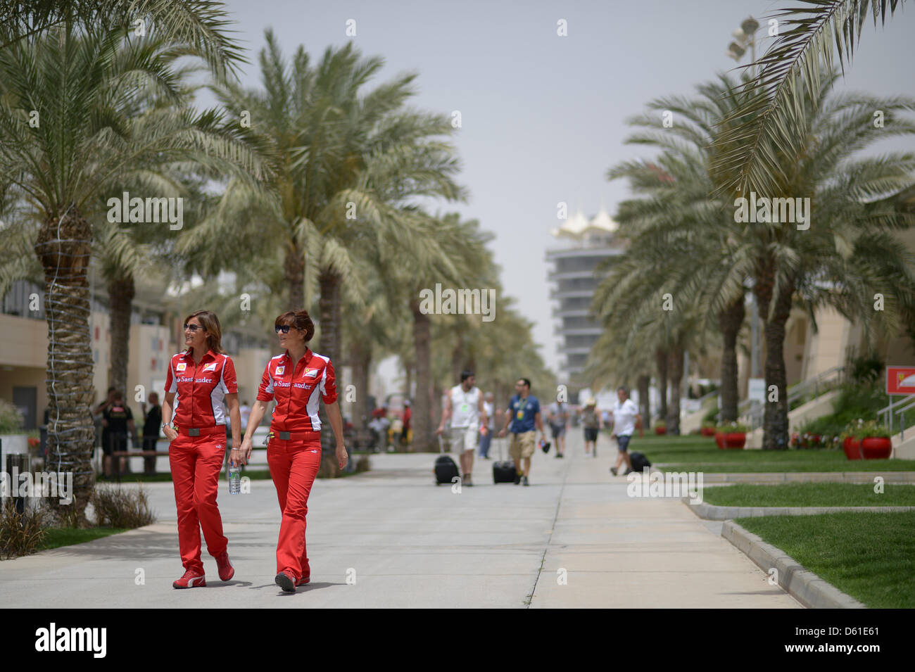Team members of Ferrari walk through the paddock of the Bahrain ...