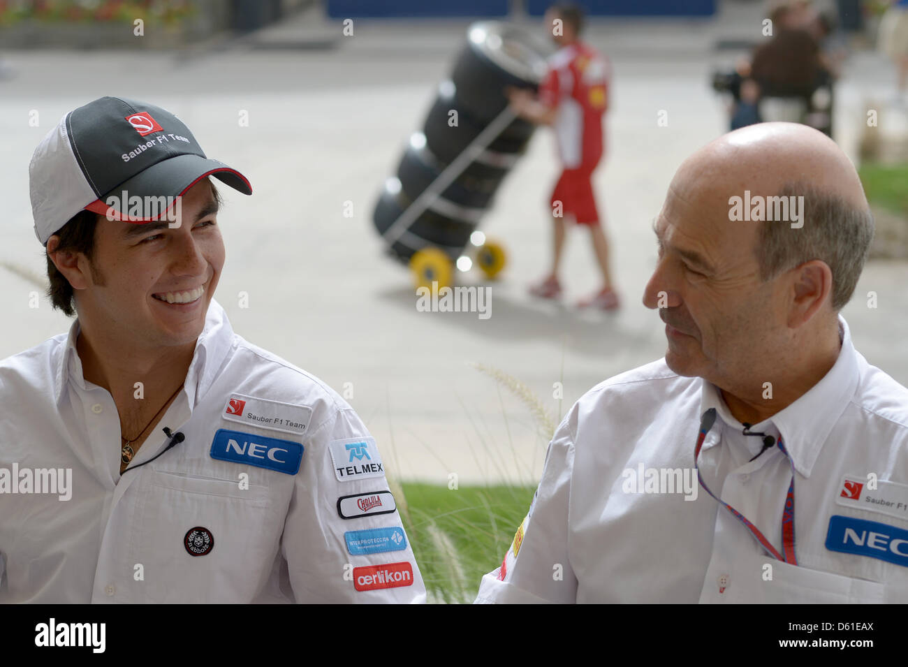 Mexican Formula One driver Sergio Perez (L) of Sauber and his team ...