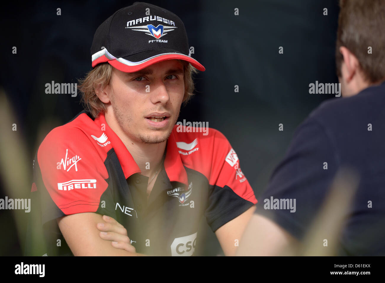French Formula One driver Charles Pic of Marussia talks to a journalist ...