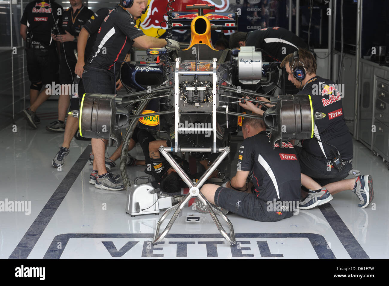 A bunch of mechanics prepare the car of German Formula One driver ...