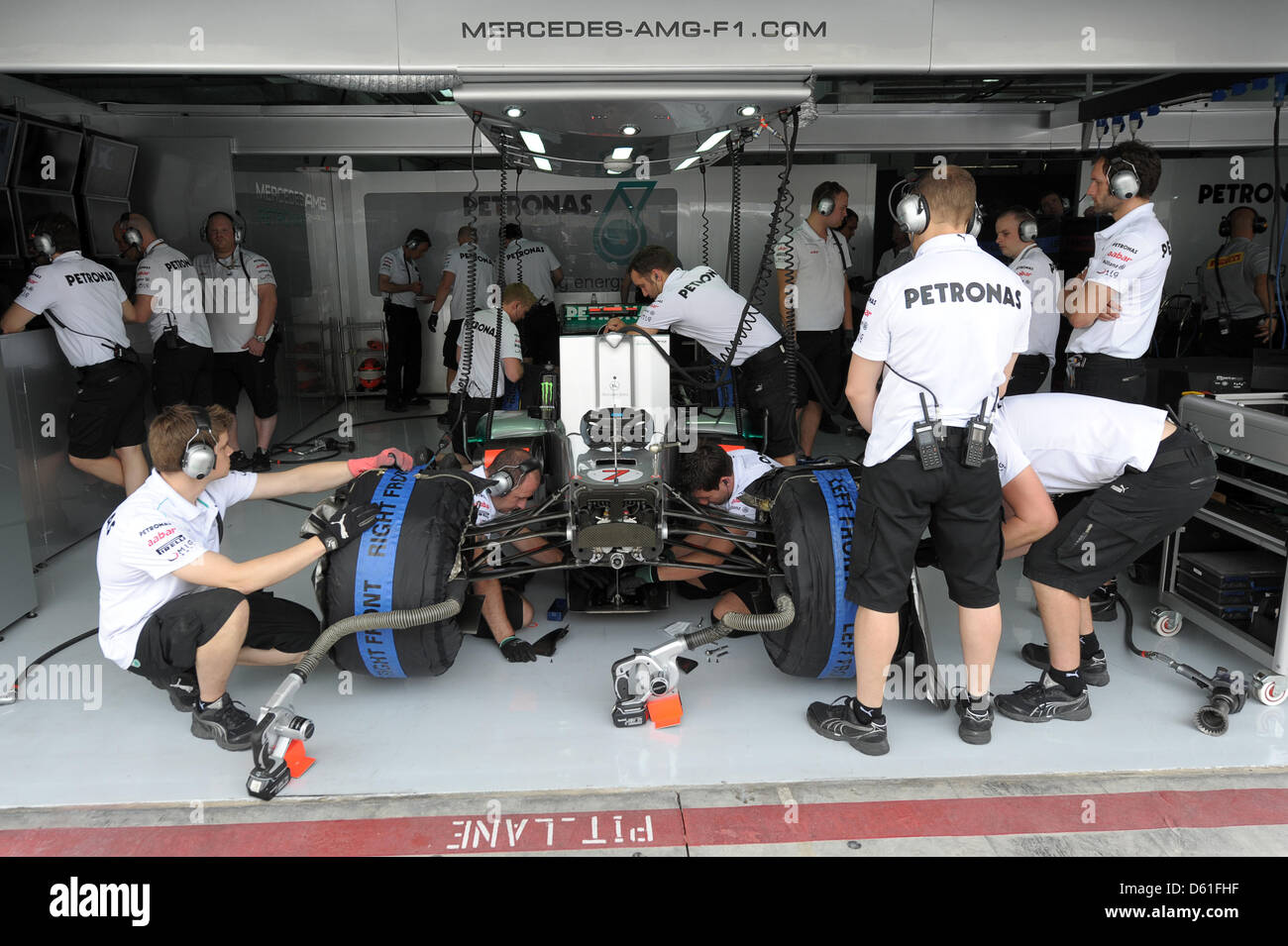 Mechanics work on the car of German Formula One driver Michael ...