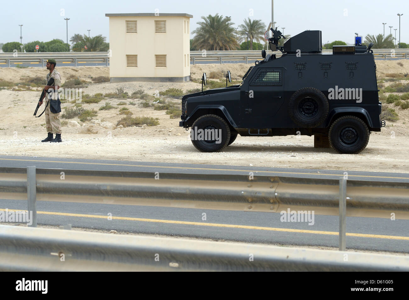 An armed Soldier next to a bullet-proof vehicle on the road to the ...
