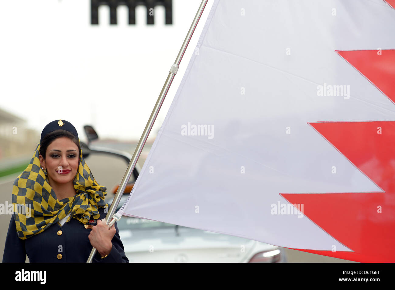A grid girl holds the national flag of Bahrain before the Formula One ...