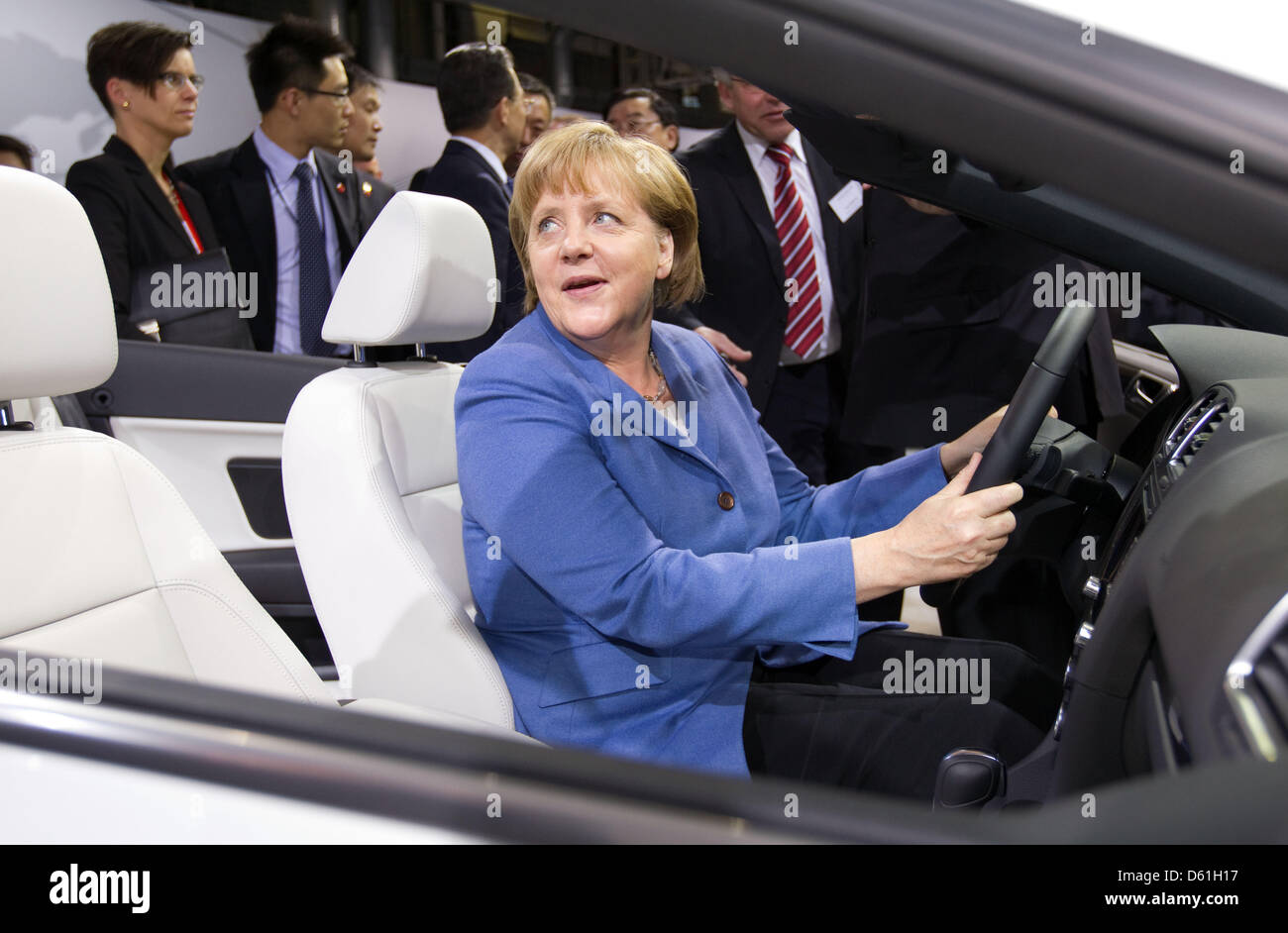 German Chancellor Angela Merkel gets behind the wheel of an E-Golf ...