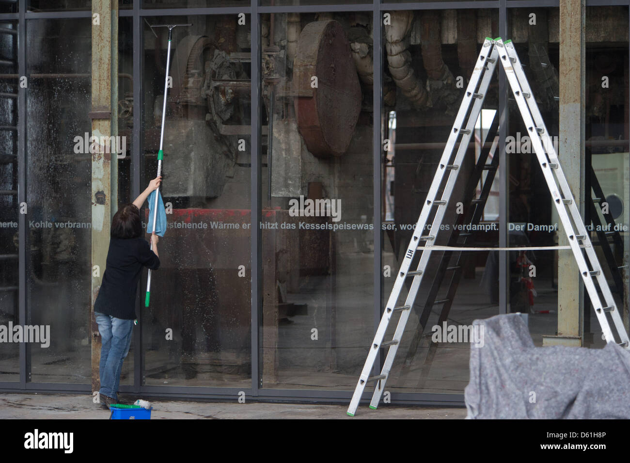 A museum cleaner cleans the glass doors to the new exhibition at the ...