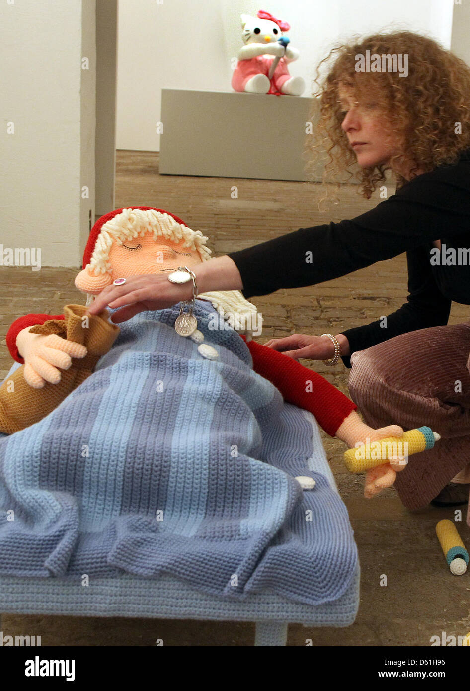 Gallery director Simone Wiechers kneels next to the east Sandmaennchen ...